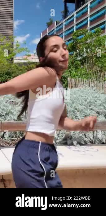 Young female dancer performing dynamic freestyle moves with passion ...