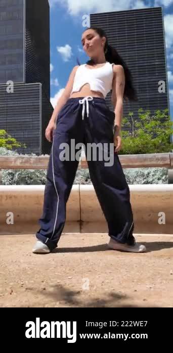 Energetic dancer performing freestyle moves in urban cityscape ...