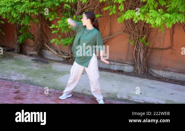 Dynamic young dancer performing modern choreography with high energy ...