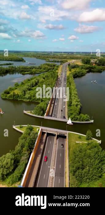 Veluwemeer Aqueduct, where a serene waterway flows above a bustling ...