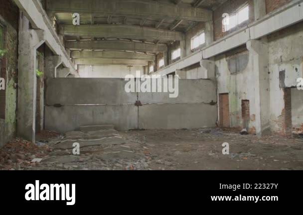 Abandoned Industrial Space with Crumbling Walls and Debris Stock Video ...