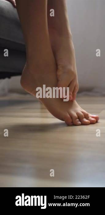 Vertical video of young woman scratch feet, itch foot, problem itchy ...