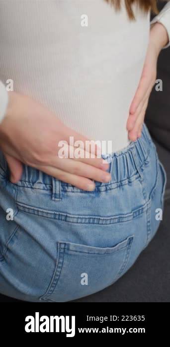 Vertical video of suffer young woman painful with back pain, back ache ...