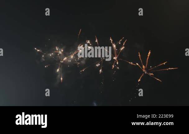 4k footage of beautiful sparkling fireworks show and play at night sky ...