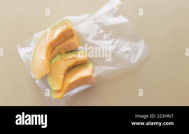 Vacuumsealed slices of fresh, juicy melon placed elegantly on a neutral ...
