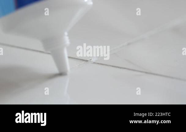 Applying sealant or grout to tile joints Stock Video Footage - Alamy