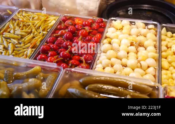 A vibrant display of assorted pickled vegetables and fruits for all to ...