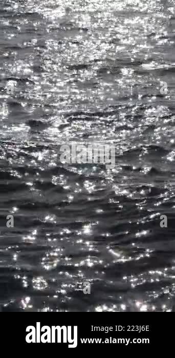 Sunlight sparkling on water surface Stock Video Footage - Alamy