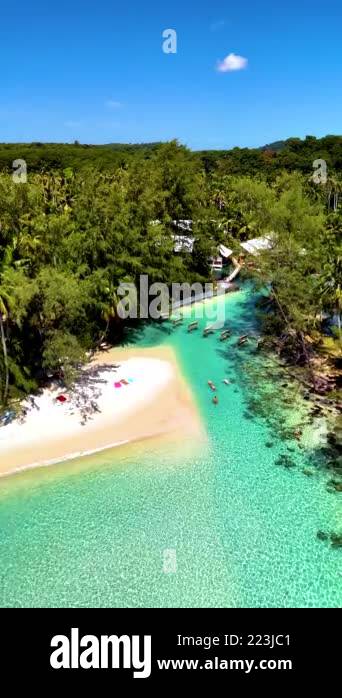 Experience the breathtaking shores of Koh Kood, Thailand, where crystal-clear waters meet soft ...