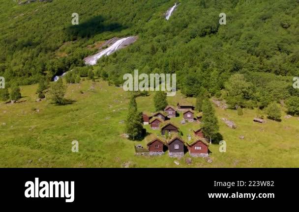 Nestled in the vibrant greenery of Norway, charming wooden cabins ...