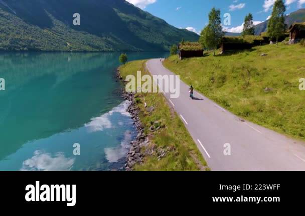 Enjoy the breathtaking beauty of Norways riverside as cyclists glide ...