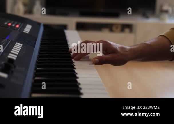 Musician hands glide effortlessly over a digital keyboard, showcasing ...