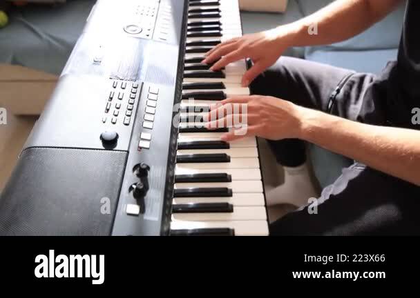 Musician hands glide effortlessly over a digital keyboard, showcasing ...