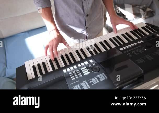 Musician hands glide effortlessly over a digital keyboard, showcasing ...