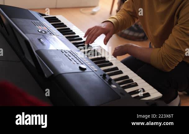 Musician hands glide effortlessly over a digital keyboard, showcasing ...