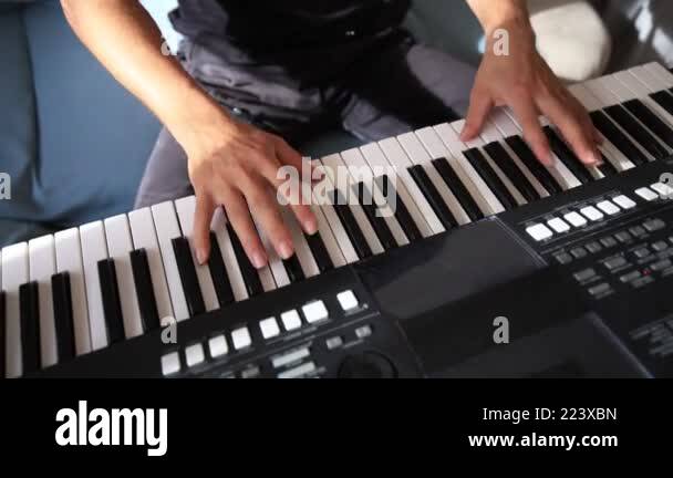 Musician hands glide effortlessly over a digital keyboard, showcasing ...