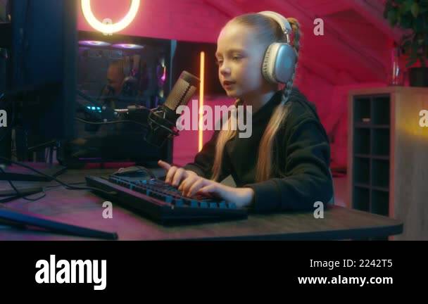 Caucasian talking to microphone little girl gamer worried difficult ...