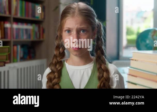Helpless sad upset anxious Caucasian little girl schoolgirl kid school ...