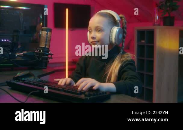 Concentrated little Caucasian girl teenager gamer streamer child kid ...