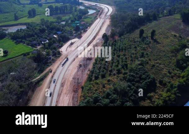 Aerial view of new road. Freeway under construction in mountainous area ...