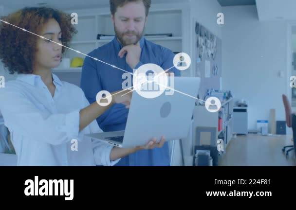 Networking icons animation over business colleagues discussing work in ...