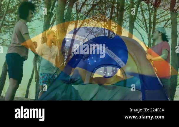 Brazilian flag animation over people setting up tent in forest. Camping ...