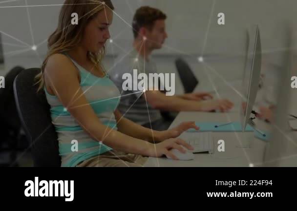 Network connections animation over students typing on computers in ...