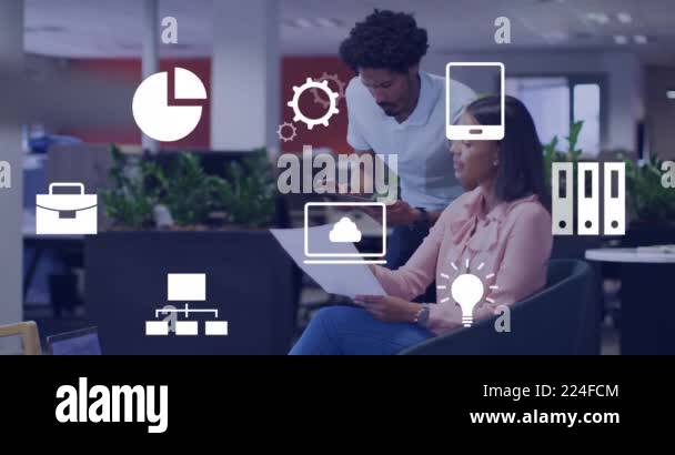 Business icons animation over colleagues discussing documents in modern ...