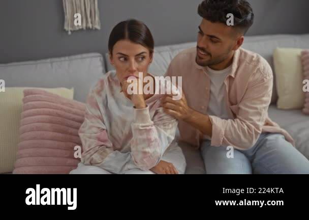 Man comforting woman on sofa in cozy home interior highlighting ...