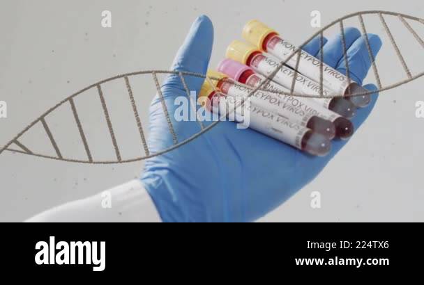 Animation of dna strand spinning over hand with test tubes with blood ...