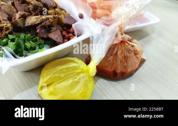 A bowl of Indonesian local bubur porridge with assorted toppings ...