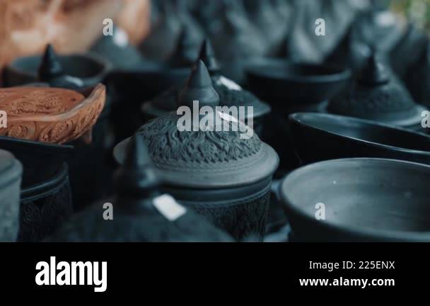 Selective focus on thai clay pots with lids standing on market shelf ...