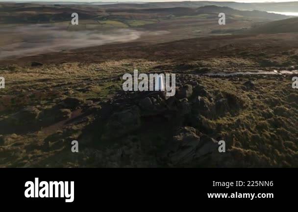 Fast aerial drone orbit reveal shot of The Roaches trigonometry point ...