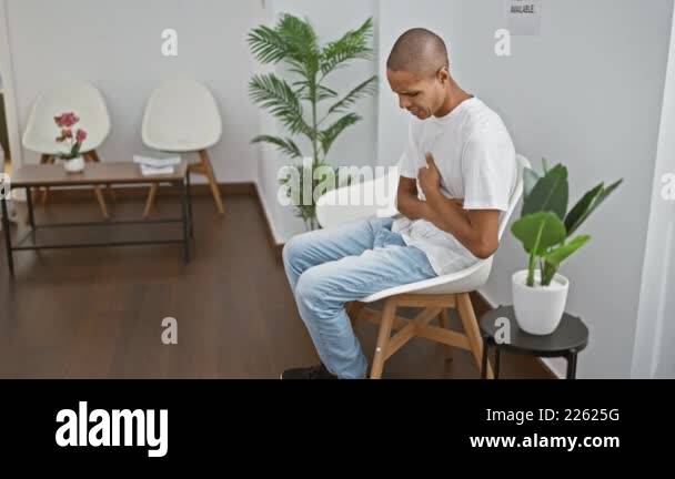 Suffering patient and professional doctor sitting together in clinic's ...