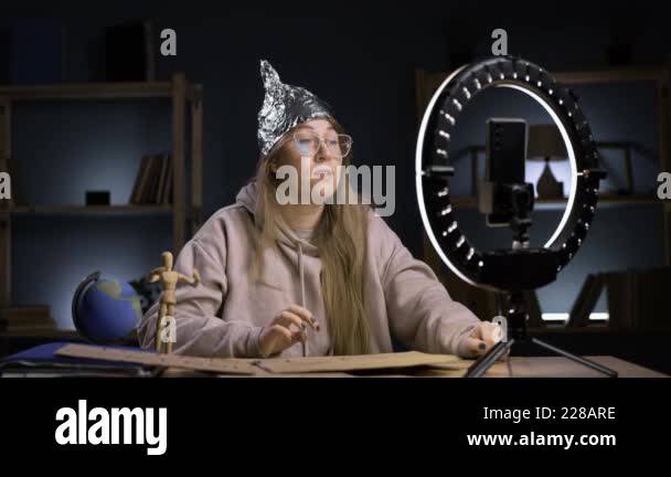 Strange crazy blogger with ring light and smartphone, paranoid woman streaming at home ...