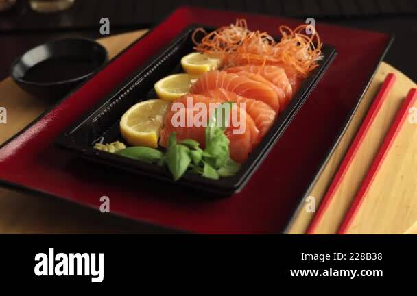 Sashimi served on vibrant red plate brings touch of elegance to ...