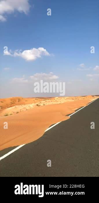 Vertical screen:Desert road stretches endlessly through wilderness ...