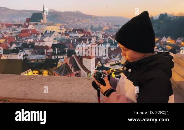 A young photographer stands in awe as he admires the stunning city view ...