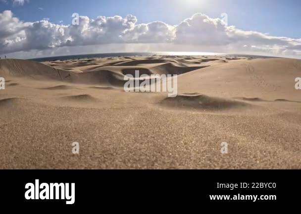 Witness the mesmerizing movement of sand as it dances through the wind ...