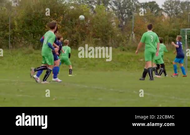 During an exciting outdoor match on a grassy field, youth soccer ...