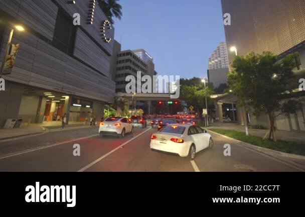 Point of view car driving in Miami city at night. Illuminated American ...