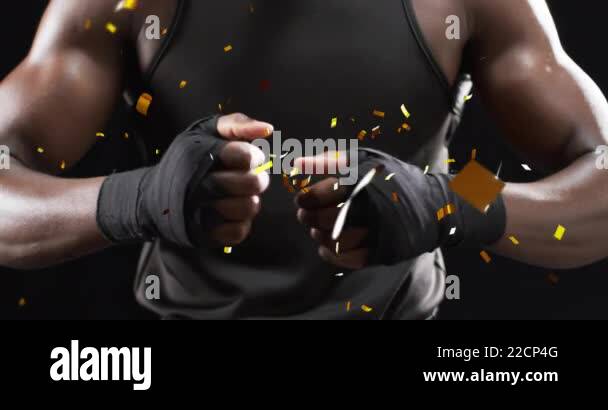 Animation of confetti falling over african american male boxer on black ...