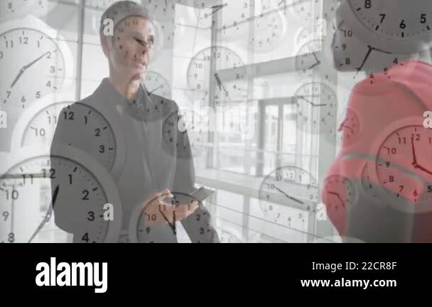 Animation of moving clocks over diverse colleagues discussing work in office. Global business ...