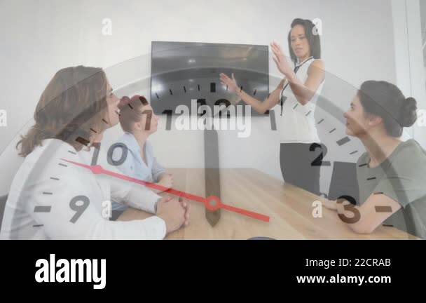 Animation of moving clock over diverse colleagues having meeting in ...