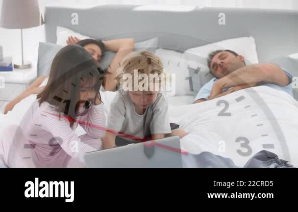 Clock animation overlay with family playing on bed with children ...
