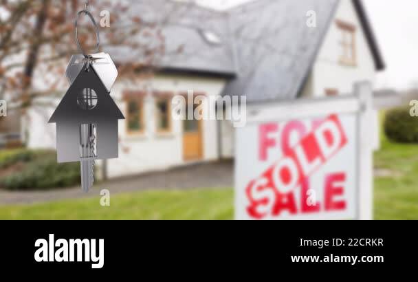 House keychain and key animation over sold sign in front of house. Real ...