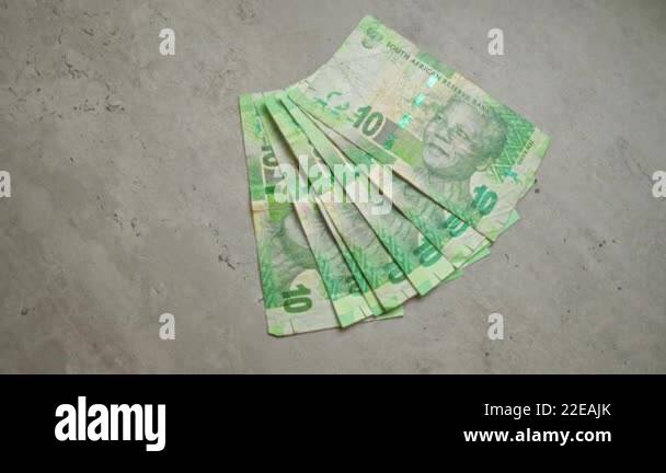 South african banknotes on a concrete surface, showcasing various ten ...