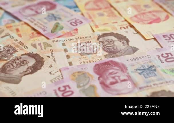Mexican pesos banknotes spread out, showcasing various denominations ...