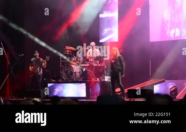 Energetic Rock Concert Performance with Dynamic Lighting and Band on ...