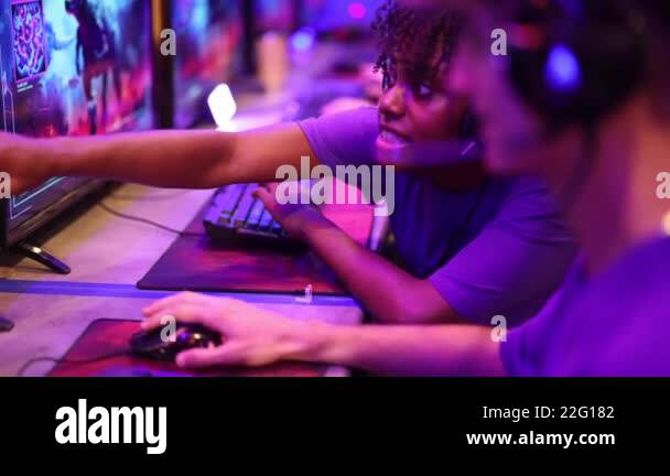 Professional gamers competing in online video game tournament, playing ...